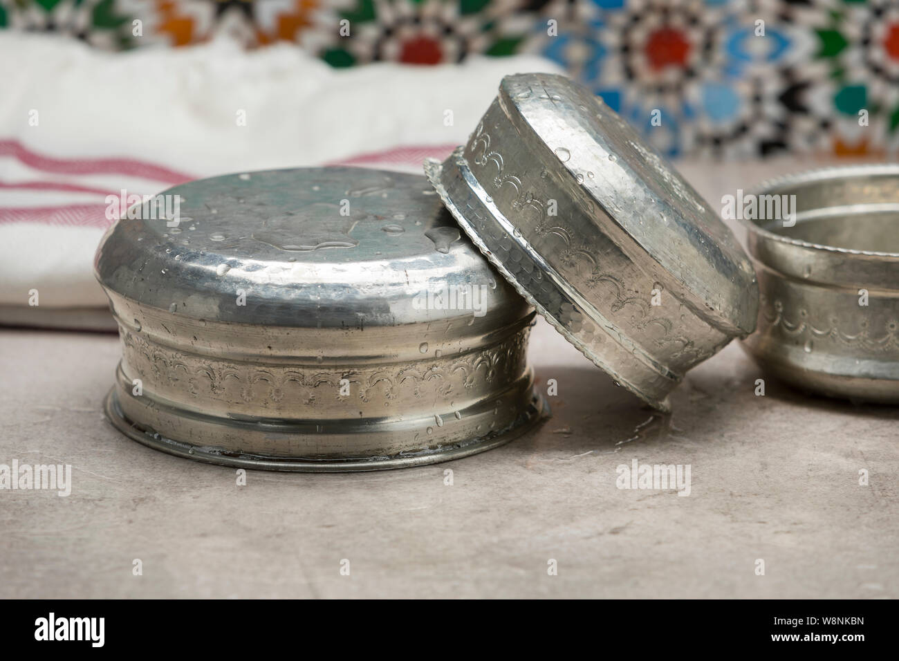 Drying stack of silver colored metal water bowls in Hammam Stock Photo ...
