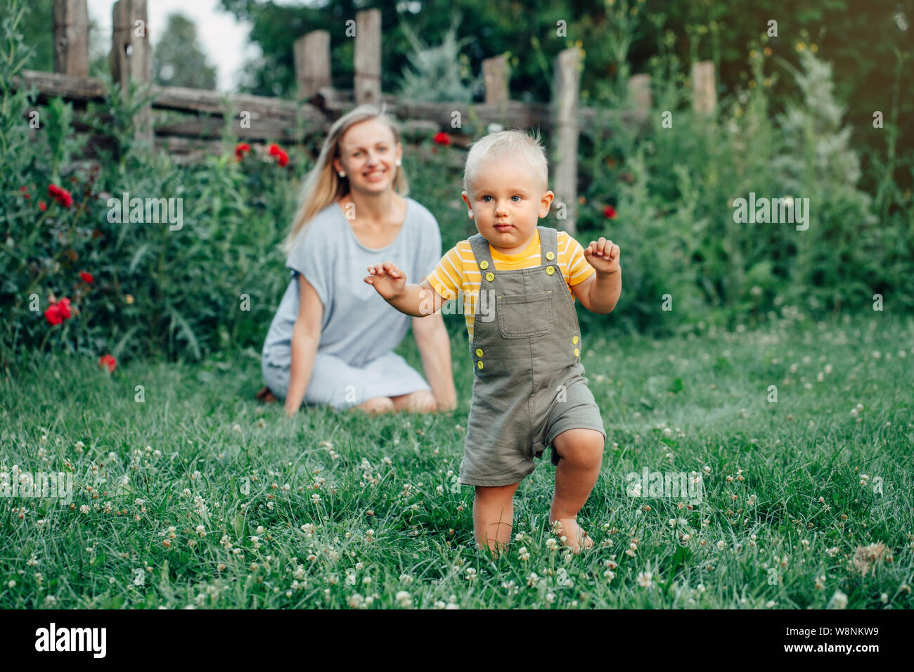 Mother watching child walk hi-res stock photography and images - Alamy