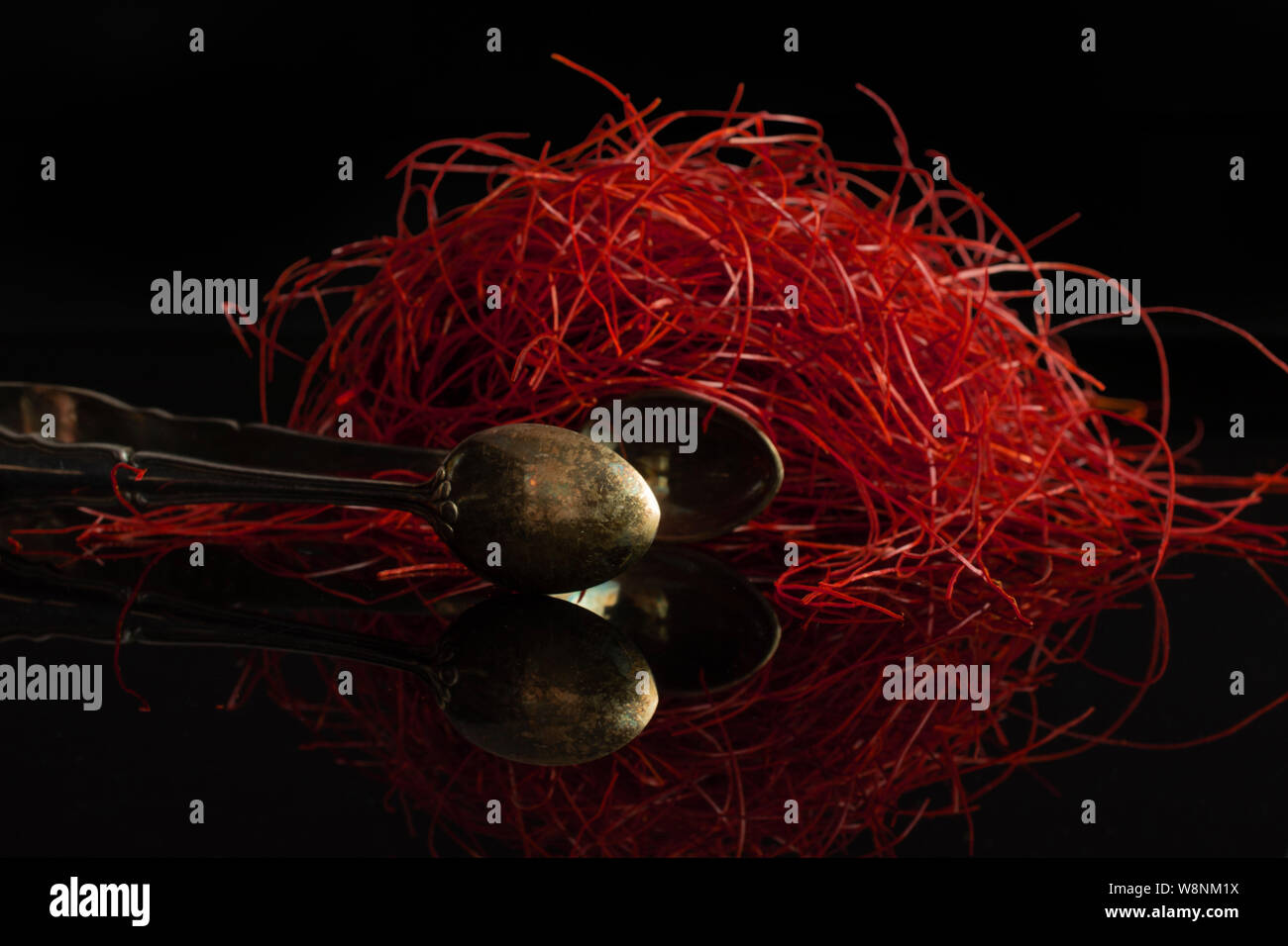 Lot of whole red chili pepper threads with sugar tongs isolated on ...