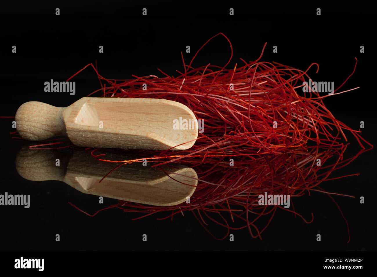 Lot of whole red chili pepper threads with wooden scoop isolated on ...