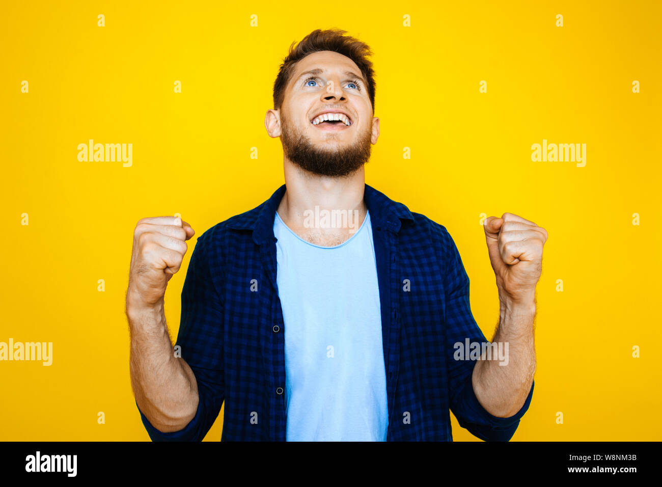 Handsome young guy gesturing with hands and looking up with grateful ...