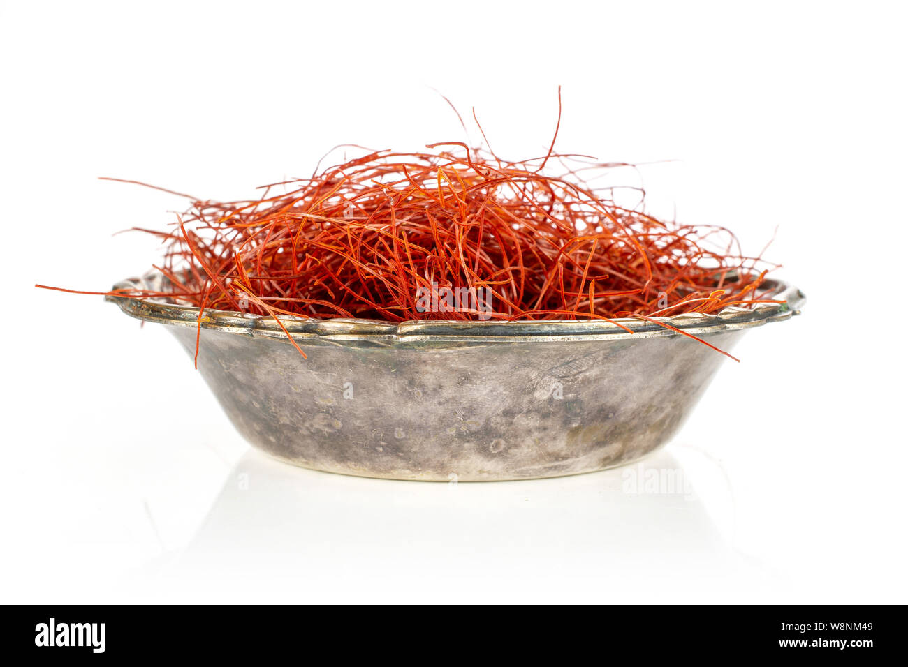 Lot of whole red chili pepper threads in old iron bowl isolated on ...