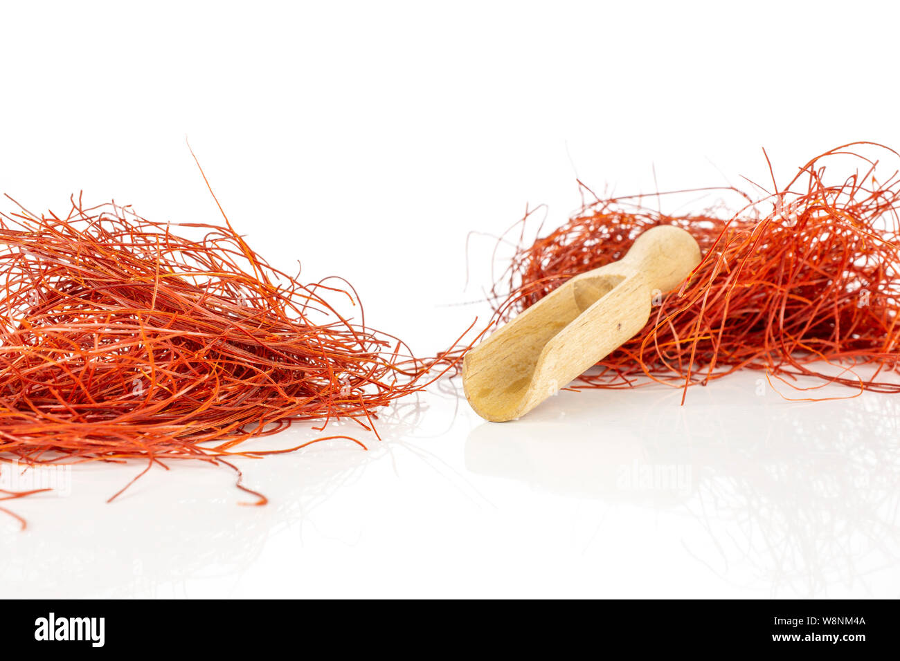 Lot of whole red chili pepper threads two stacks with wooden scoop ...