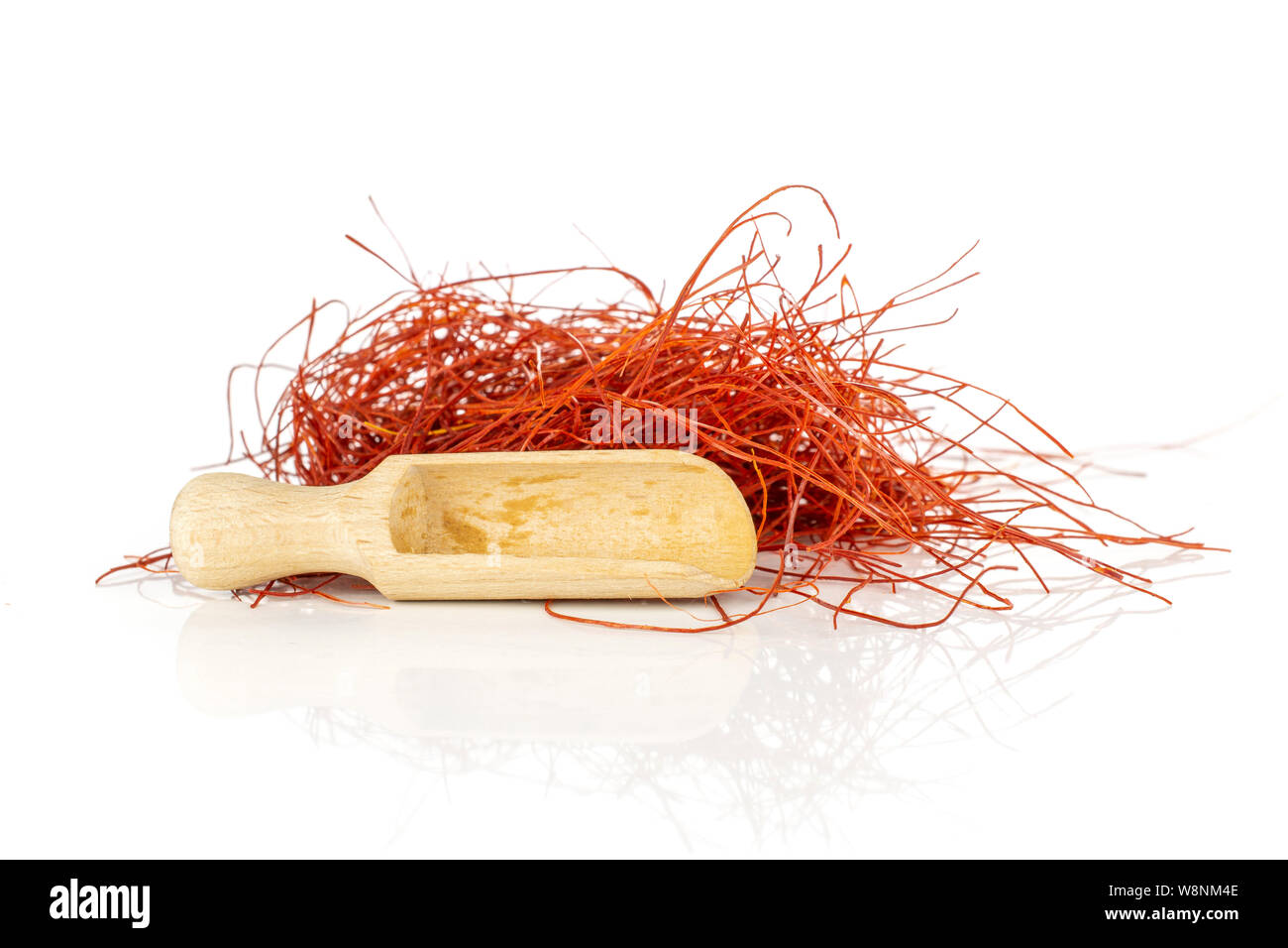 Lot of whole red chili pepper threads with wooden scoop isolated on ...