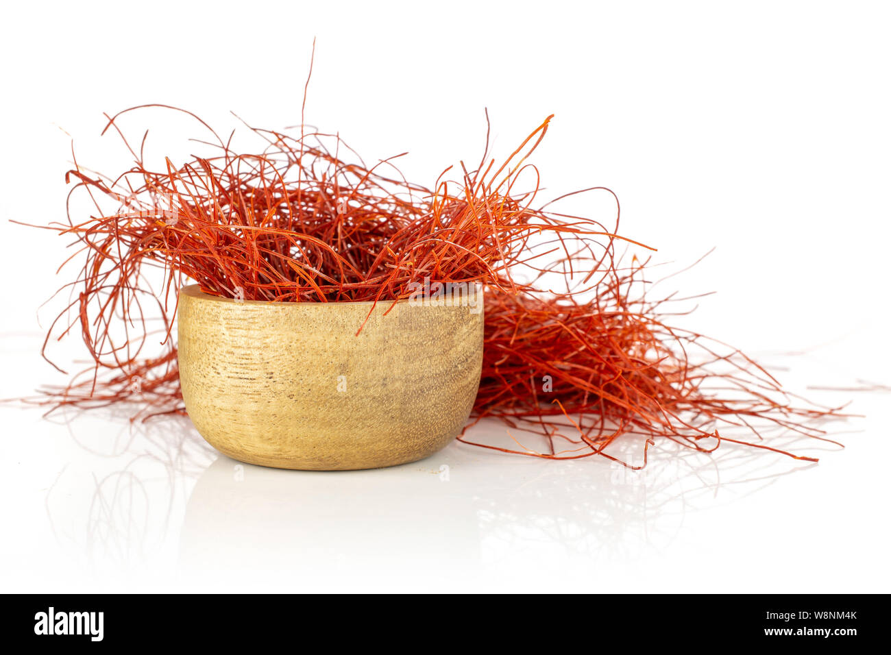 Lot of whole bright red chili pepper threads in wooden bowl isolated on ...