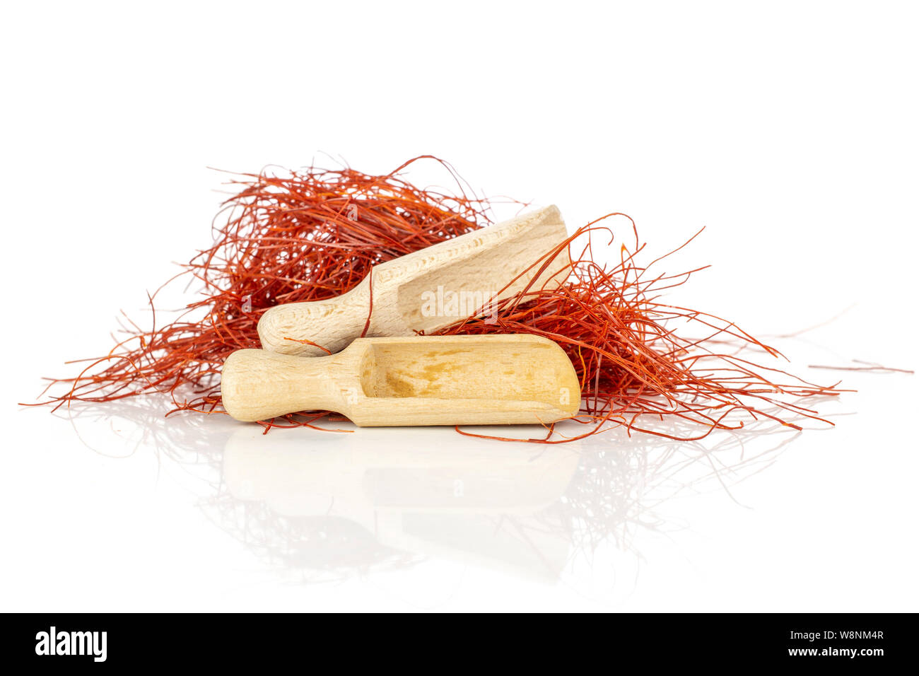 Lot of whole red chili pepper threads with wooden scoop isolated on ...