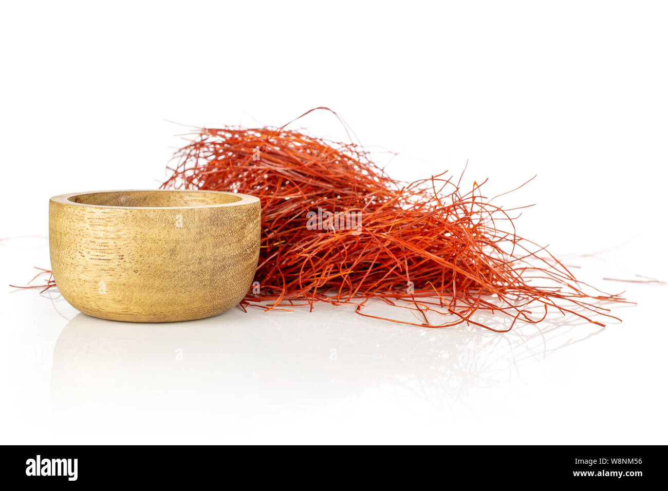 Lot of whole red chili pepper threads in wooden bowl isolated on white ...
