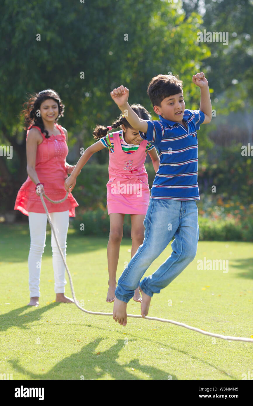 Mother And Daughter Jumping Garden High Resolution Stock Photography ...