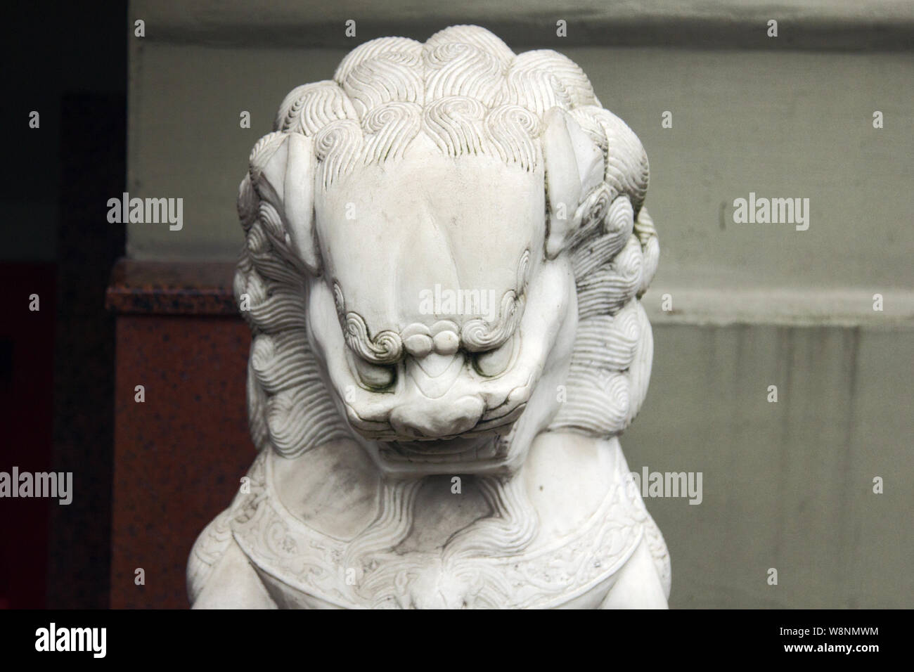 Urban sculpture. The lion is furious and with a lock on his neck as a ...
