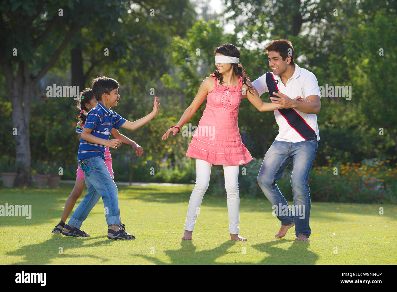 Family playing blind man bluff in a garden Stock Photo - Alamy