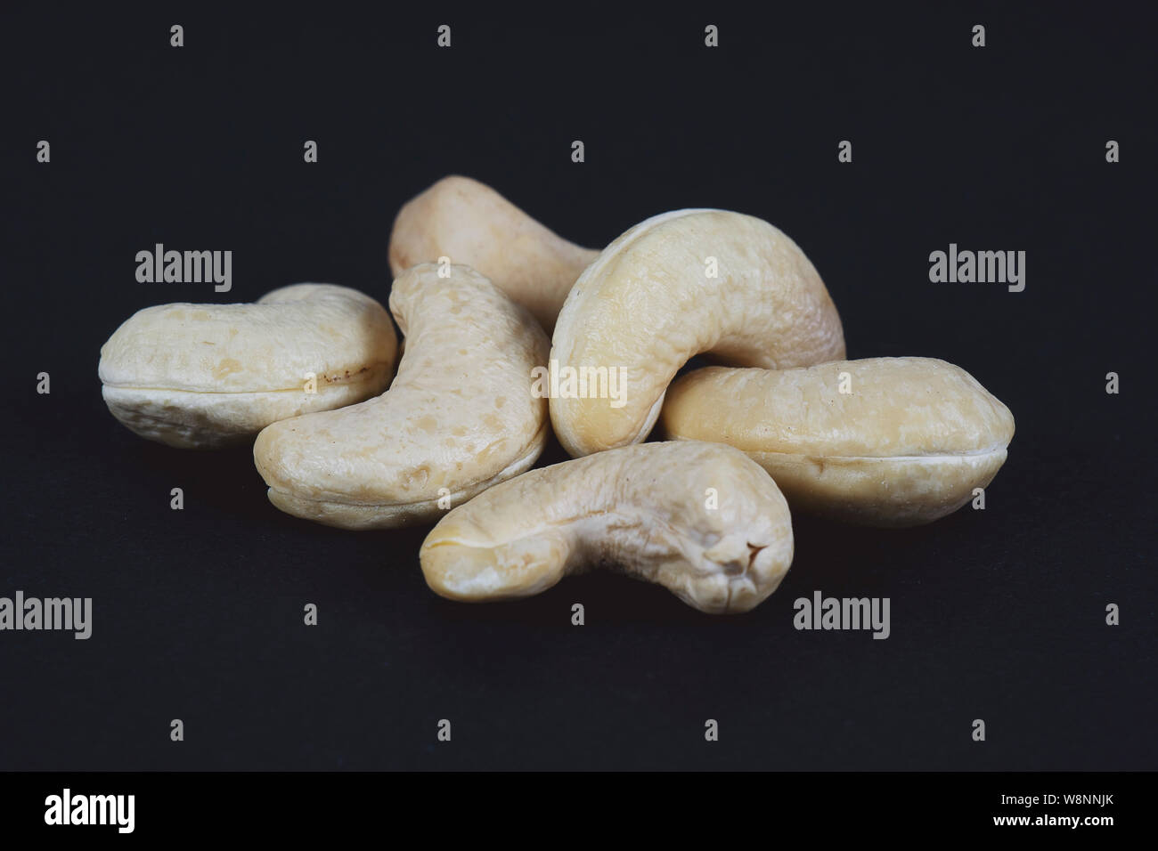 Cashews nut on black background Stock Photo - Alamy