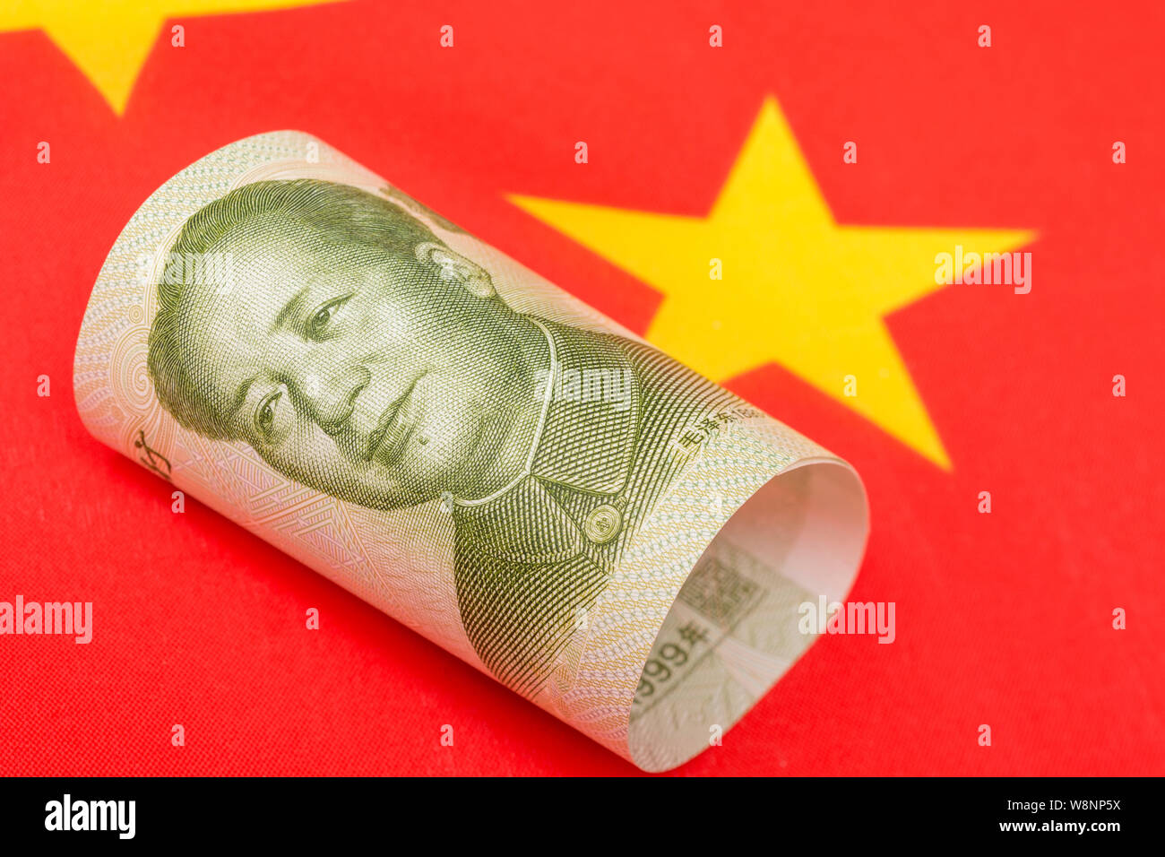 Close-up shot Chinese Yuan 1 Renminbi banknote bill & red Chinese flag ...