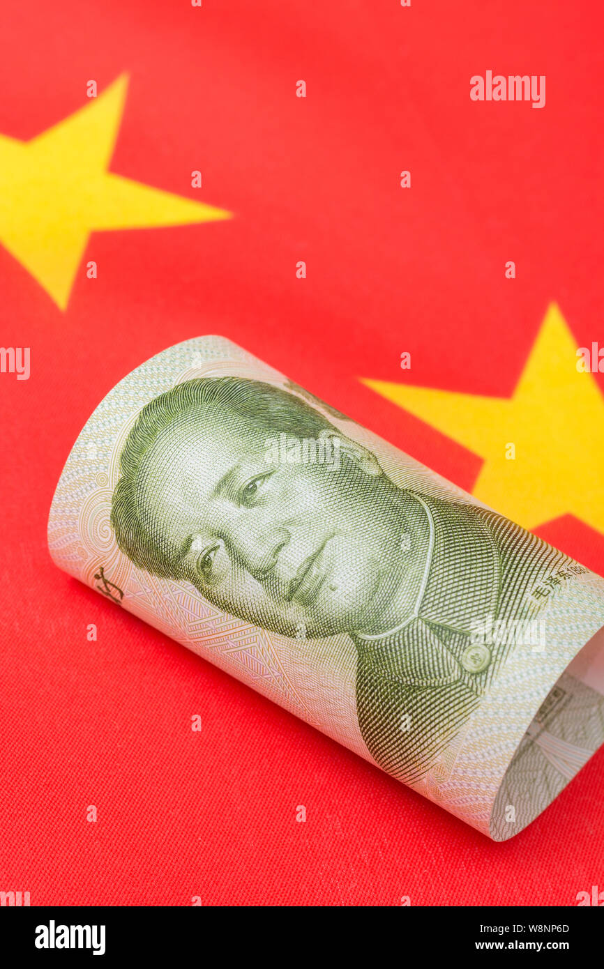 Close-up shot Chinese Yuan 1 Renminbi banknote bill & red Chinese flag ...
