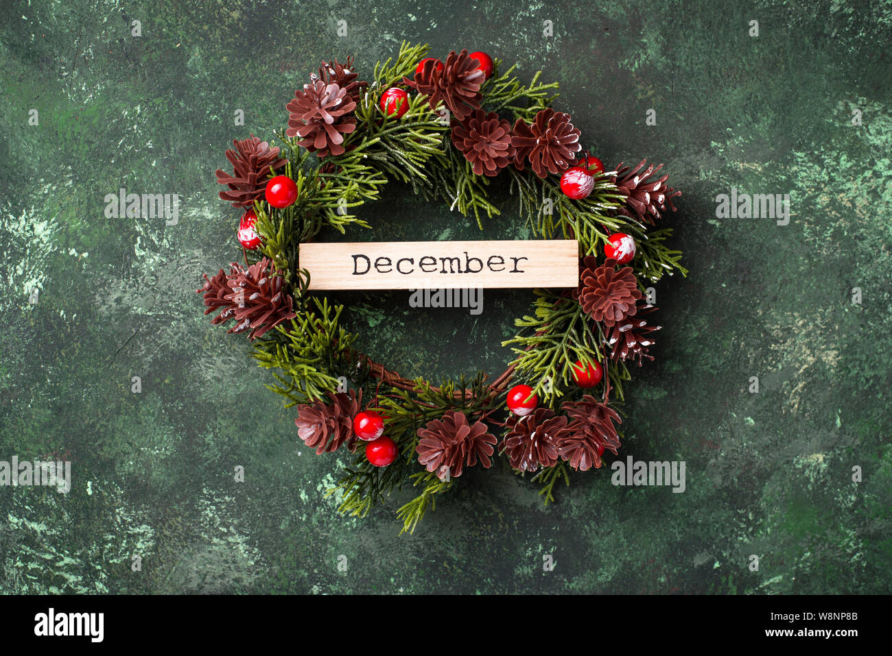 Christmas green background with wreath and text December Stock Photo ...