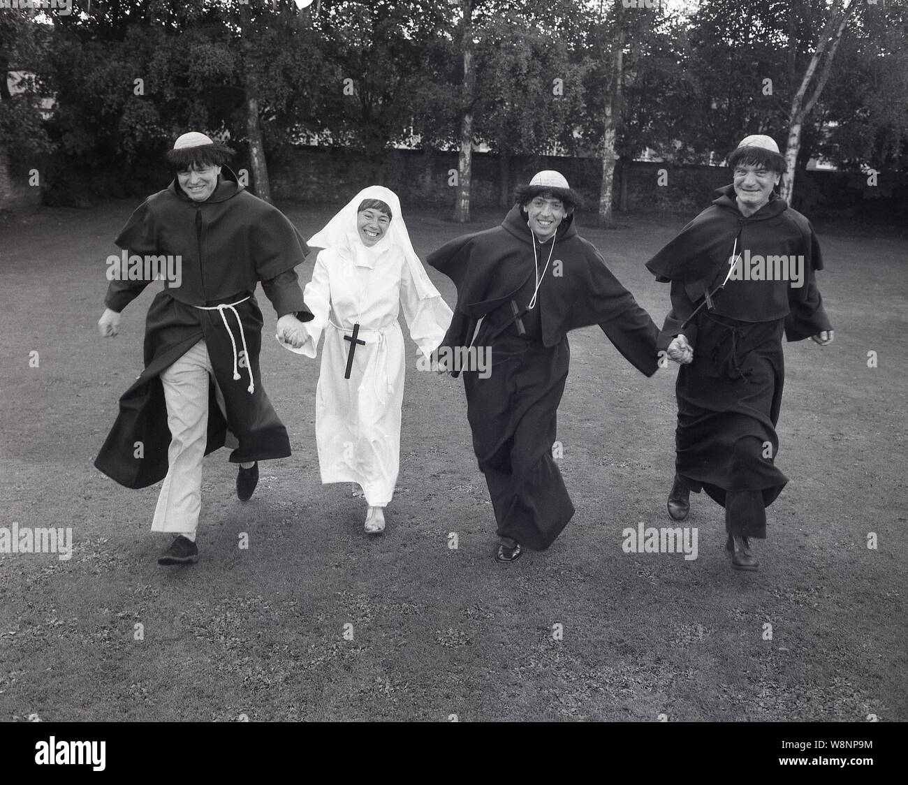 1980s, historical, men and women dressed in fancy dress, as friars and ...