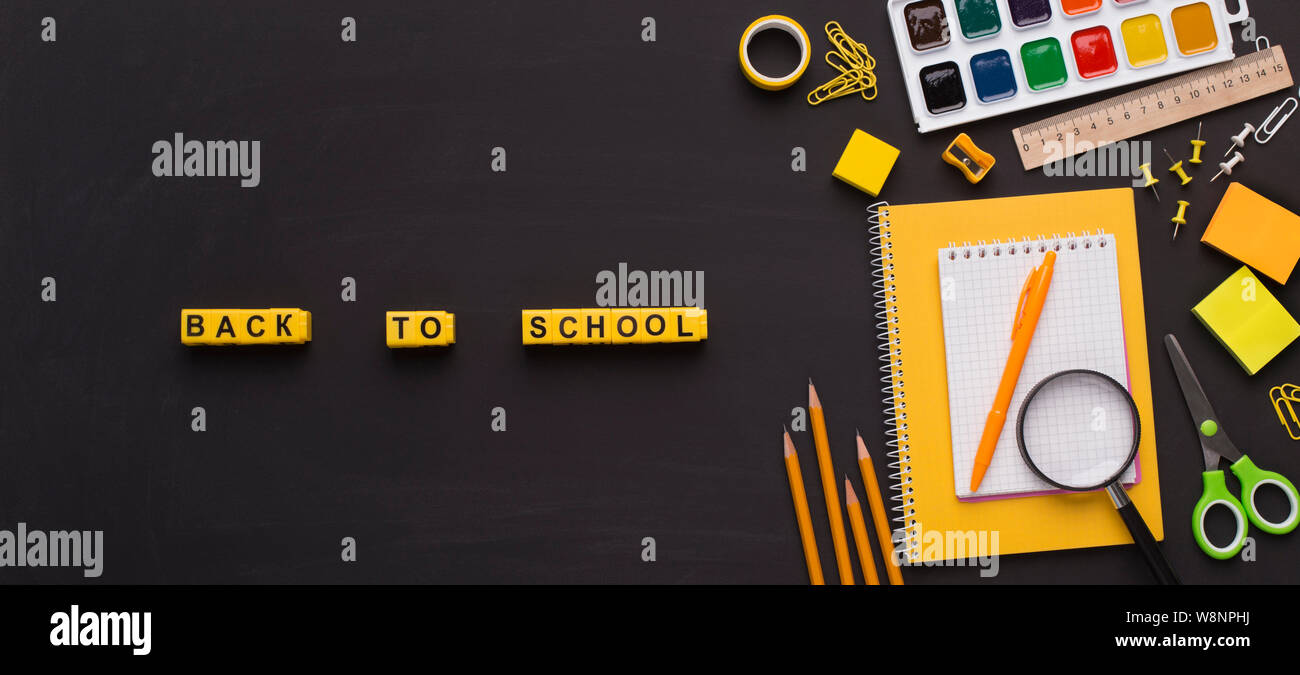 Yellow colored school supplies with back to school text Stock Photo - Alamy