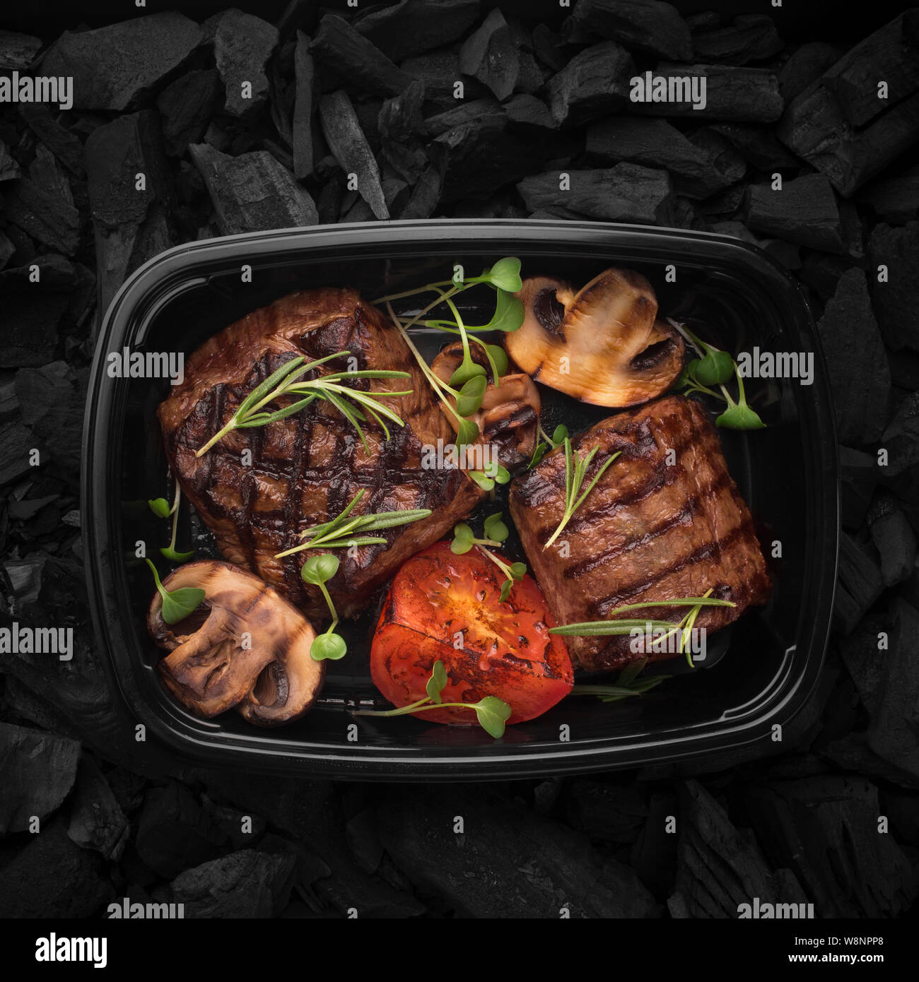 Fresh cooked meat on grill with rosemary and vegetables Stock Photo - Alamy
