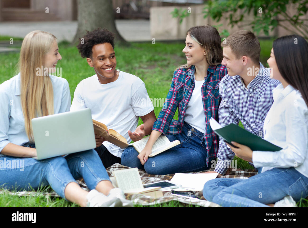 Diverse team of students resting in campus Stock Photo - Alamy