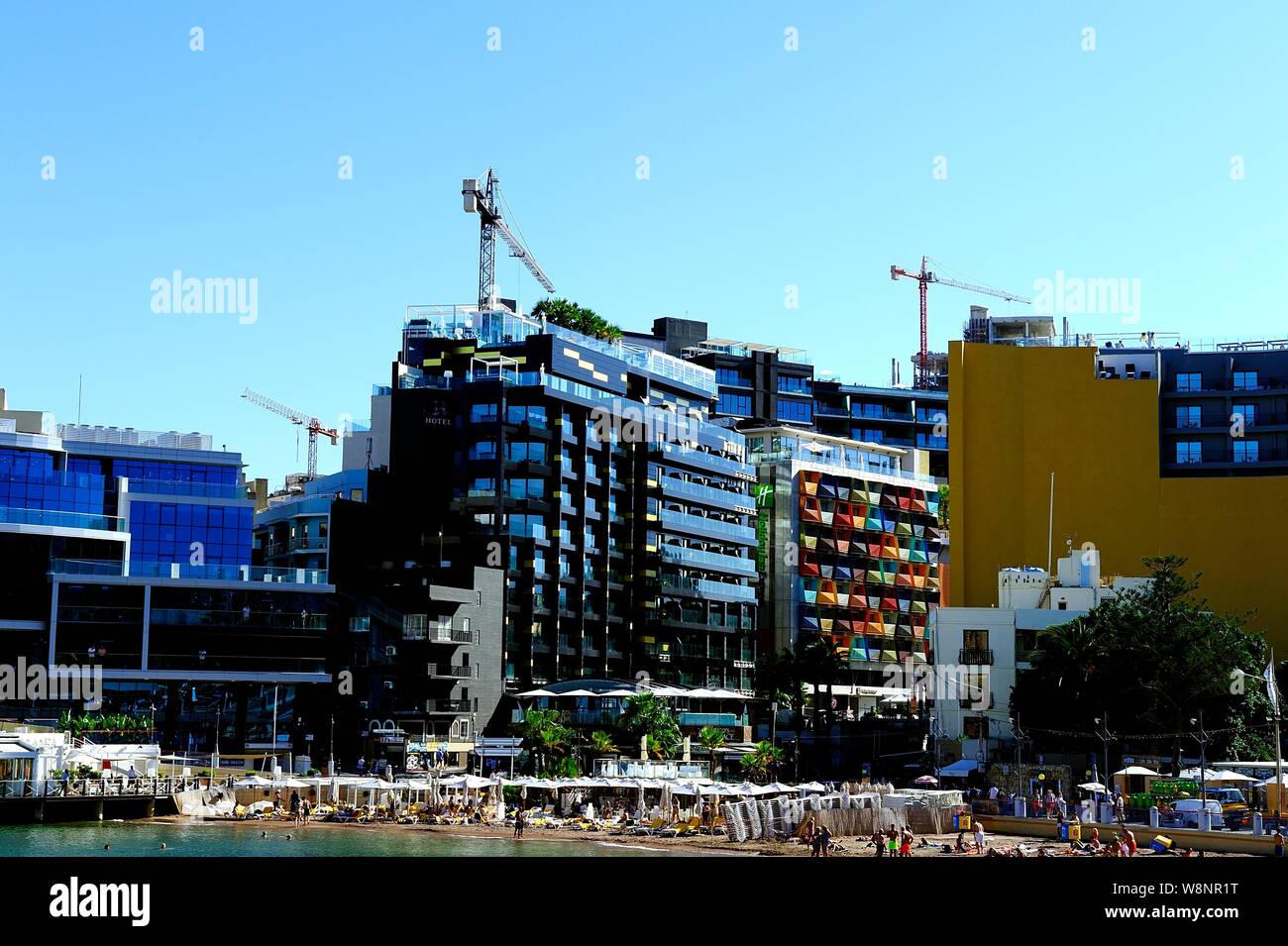 Malta - 5th October 2018:Tourists enjoying the sunshine on the beach ...