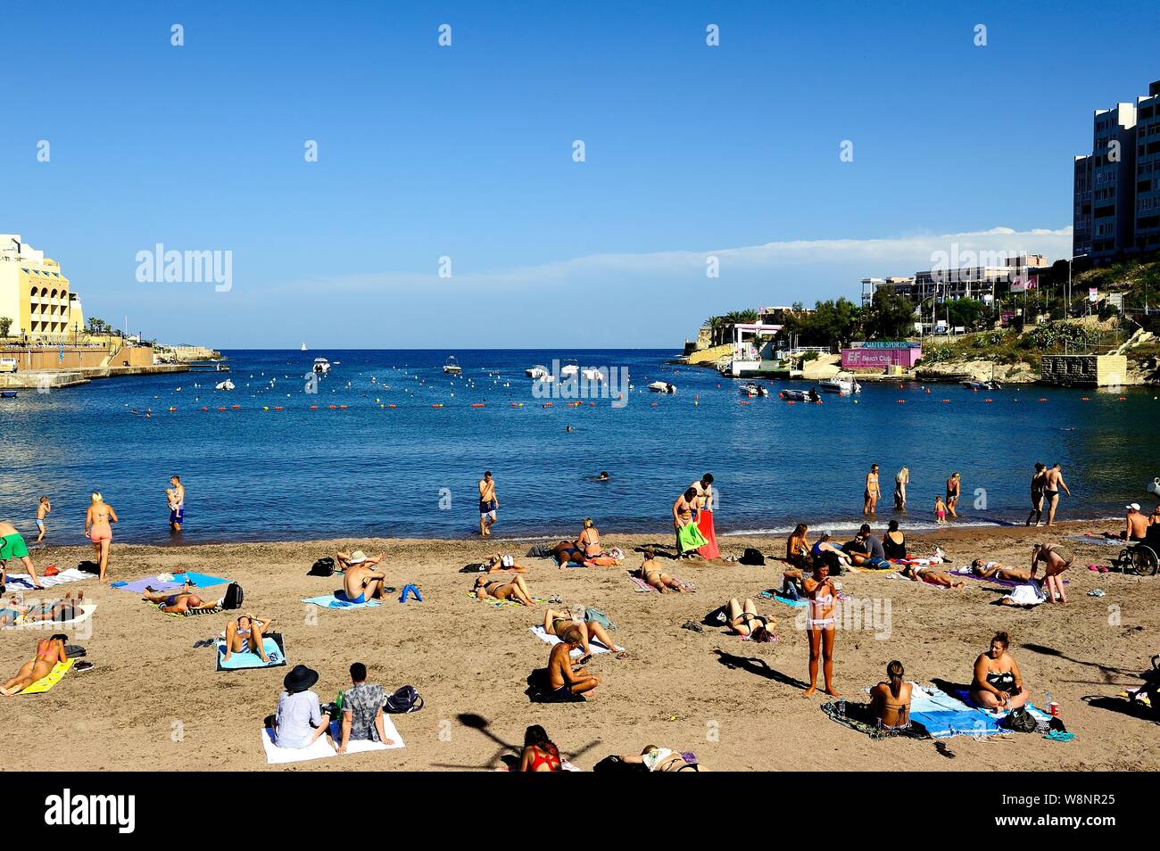 Malta - 5th October 2018:Tourists enjoying the sunshine on the beach ...