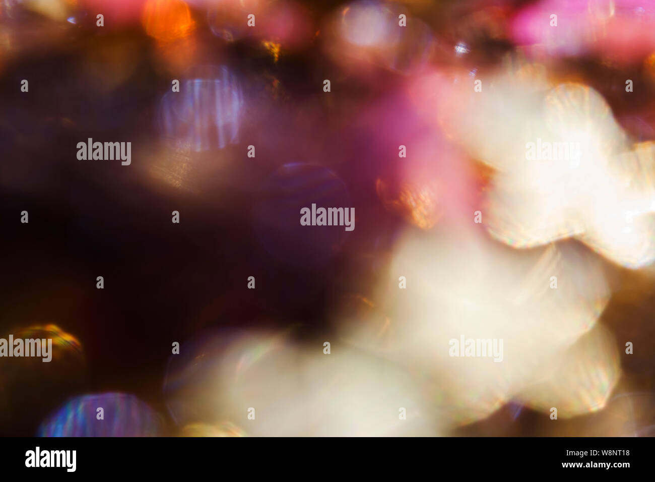 Smooth colorful specks of bright light shining on dark background Stock ...