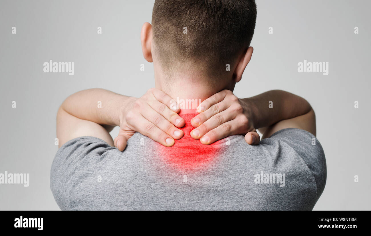 Strong man with neck pain, back view Stock Photo - Alamy