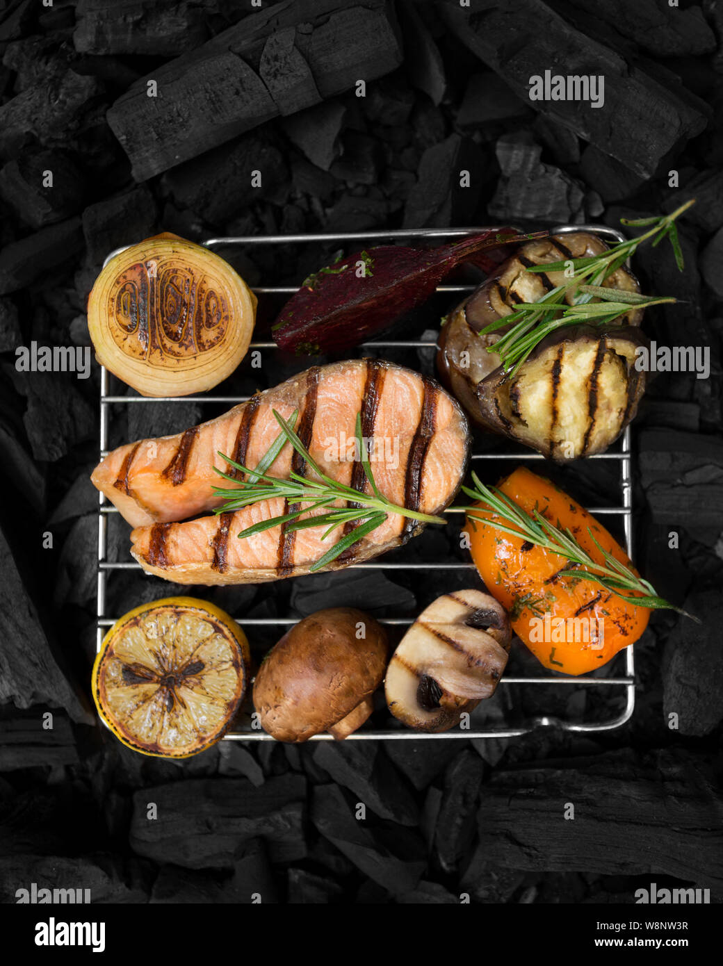 Freshly cooked on grill red fish with vegetables on grid Stock Photo ...