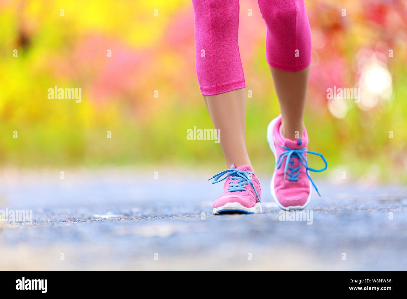 Walking and jogging woman with athletic legs and running shoes. Female ...