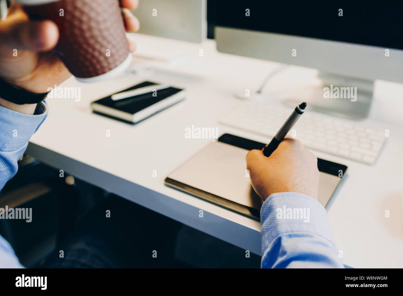 Crop unrecognizable illustrator drawing using hi-res stock photography ...