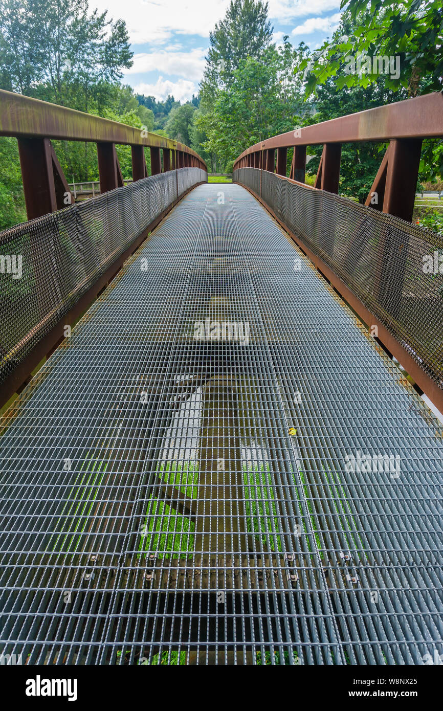 A metal grid covers a walking bridge that spans the Green River in Kent ...