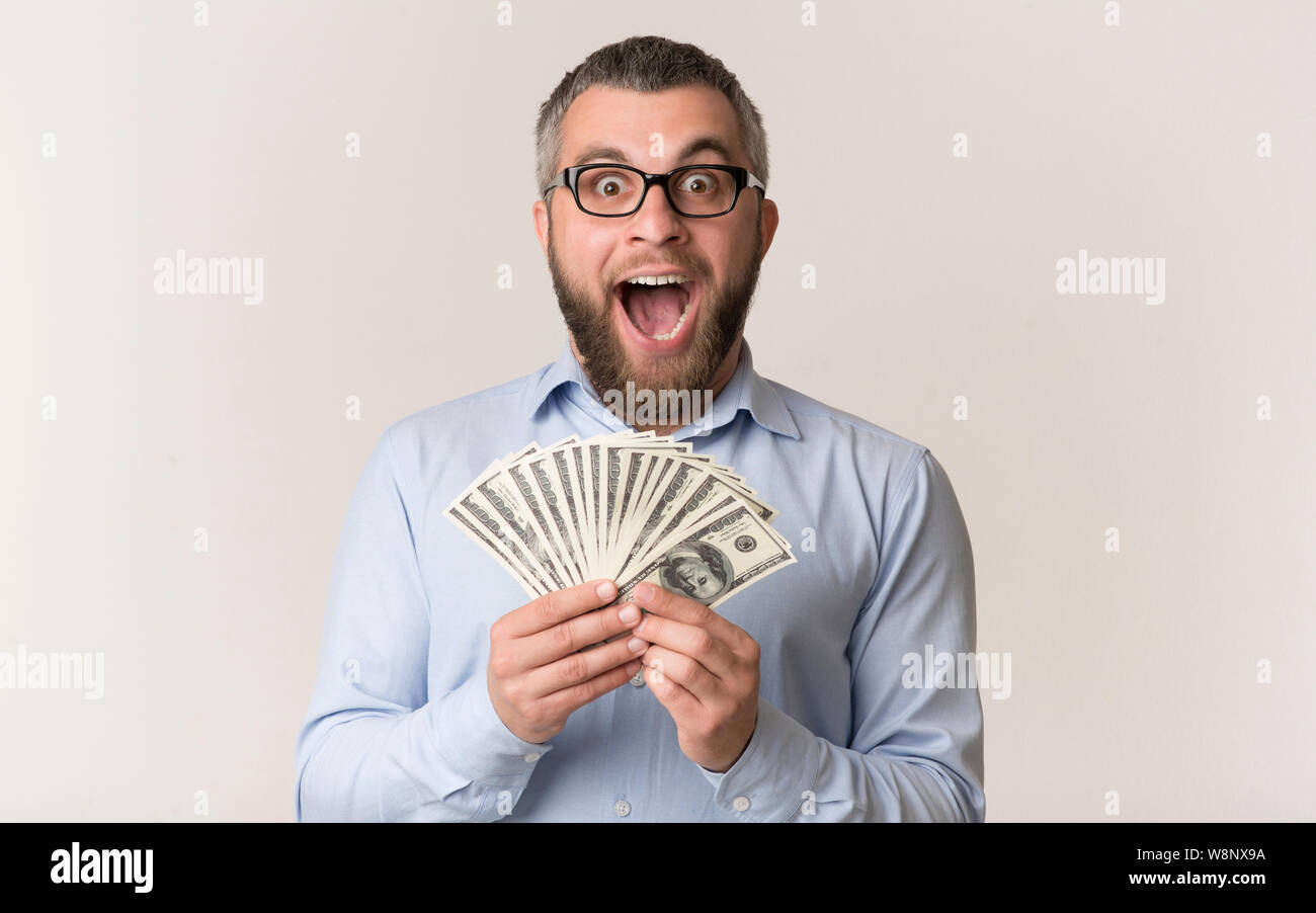 Extremely happy bearded caucasian man holding money Stock Photo - Alamy