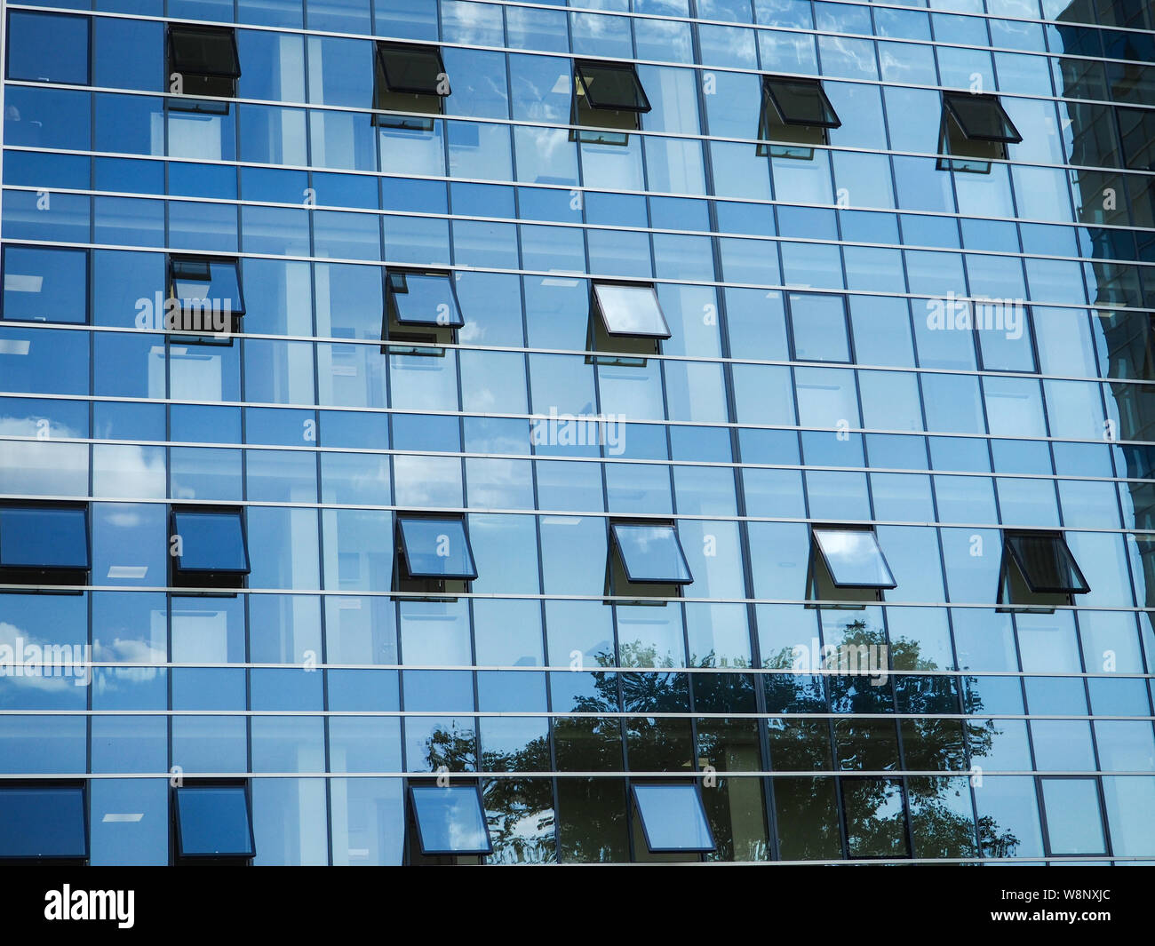 Modern building glass windows with sky reflection Stock Photo - Alamy