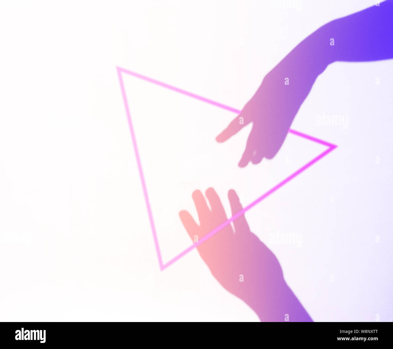 two female hands reach out for each other. neon tinted with a triangle ...