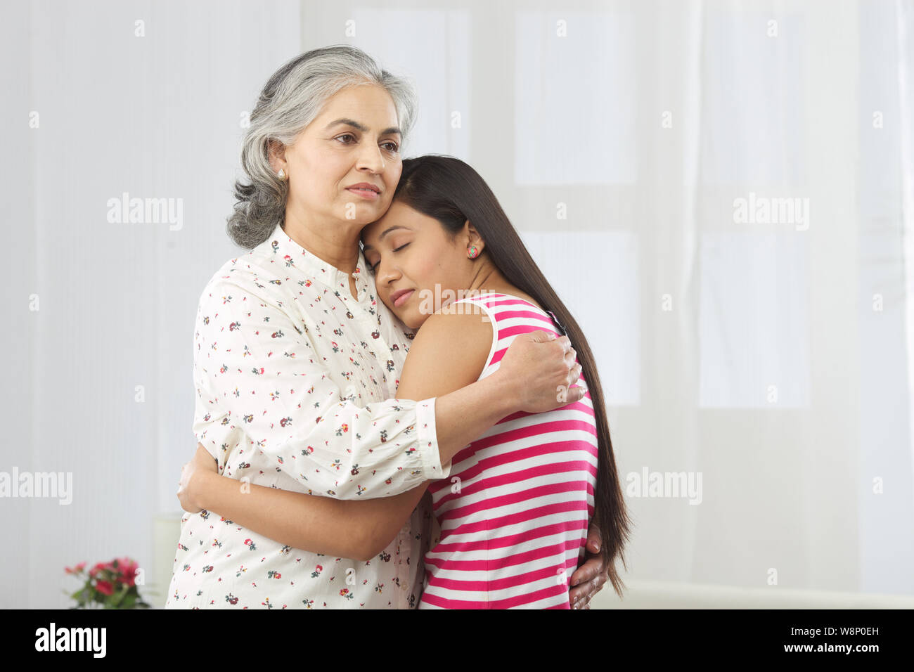 Indian young woman hugging mother hi-res stock photography and images ...