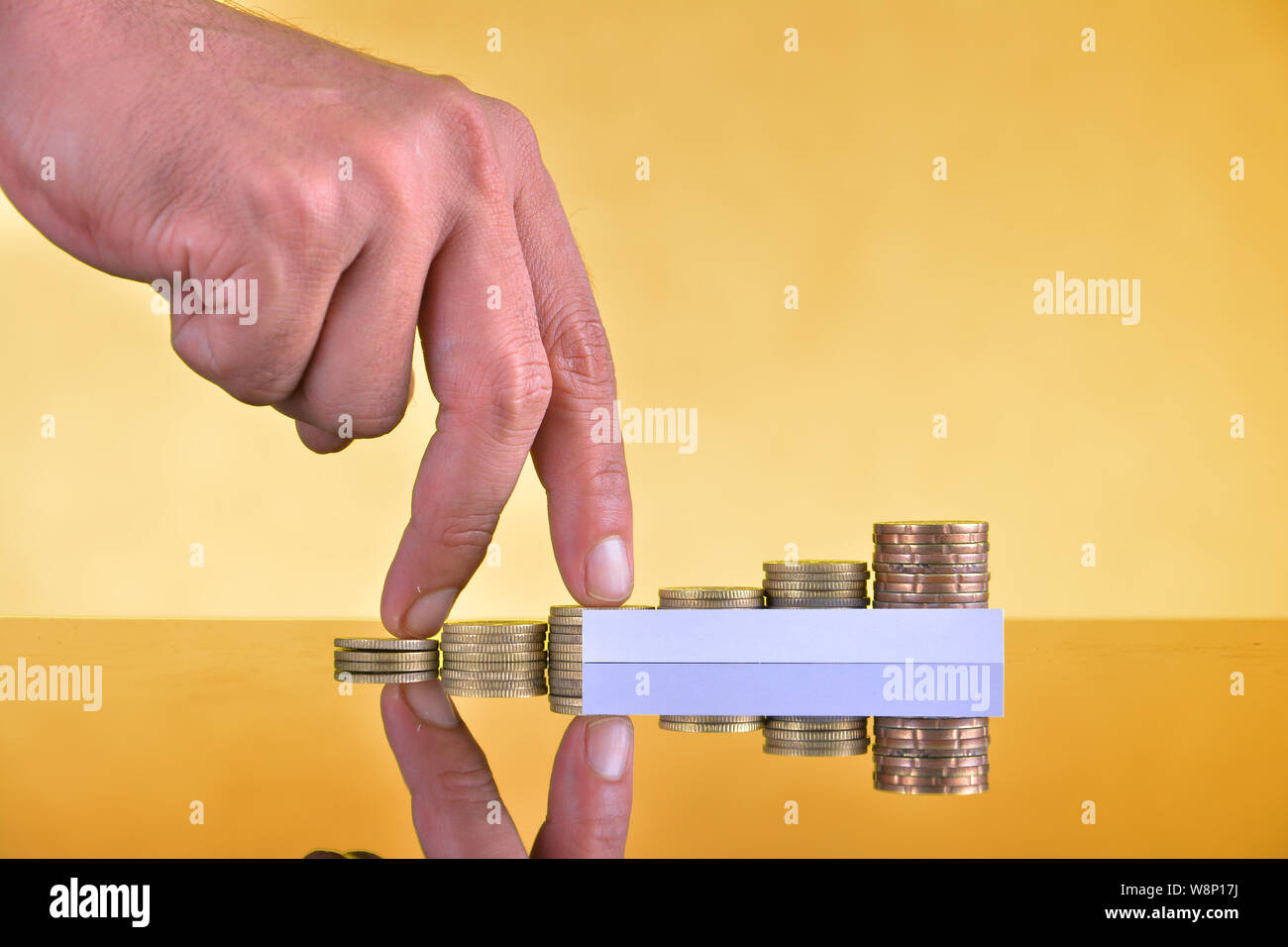 Coins stand vertically in columns ascending,revenue growth concept ...