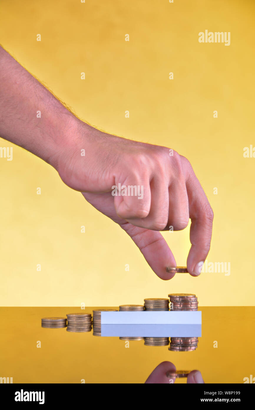 Hand put coin use for money financial banking concept Stock Photo - Alamy