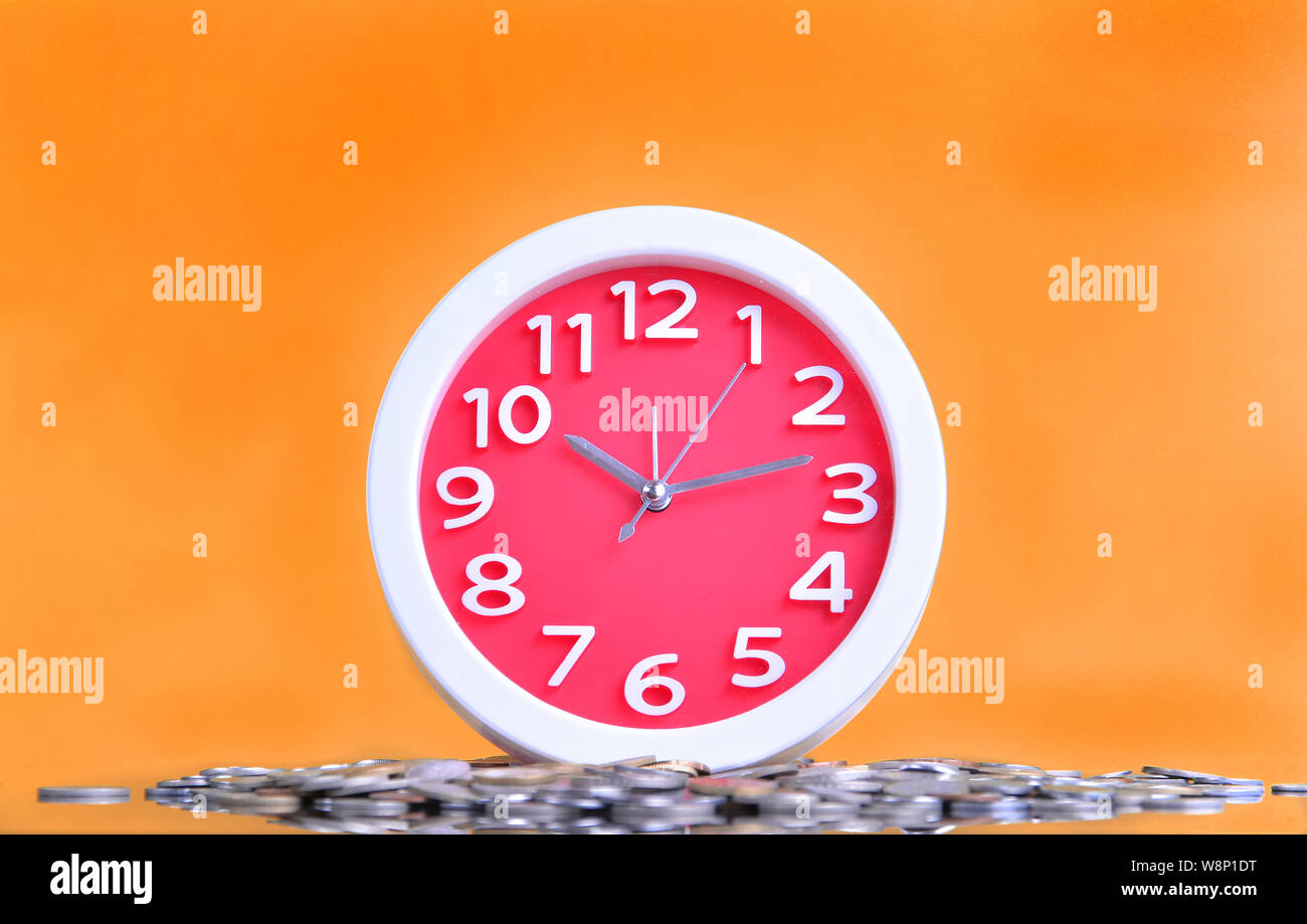 Clock golden coins stack hi-res stock photography and images - Alamy