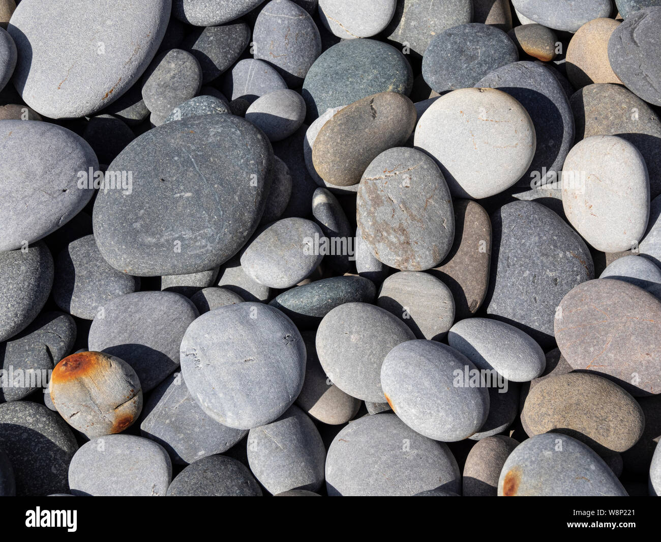 Closeup of smooth oval shaped gray rocks Stock Photo - Alamy