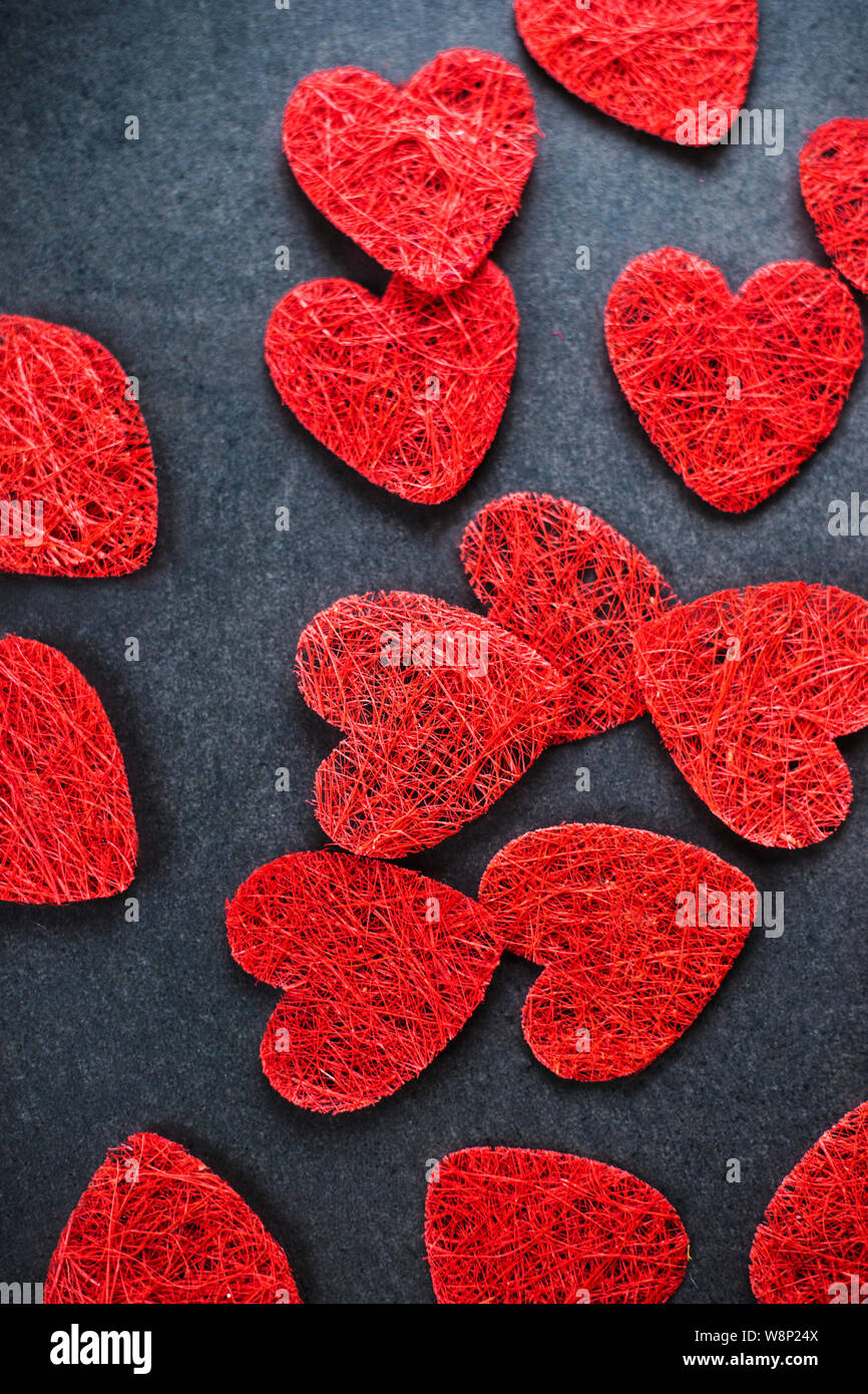 From above composition of ornament red symbols of heart on black ...