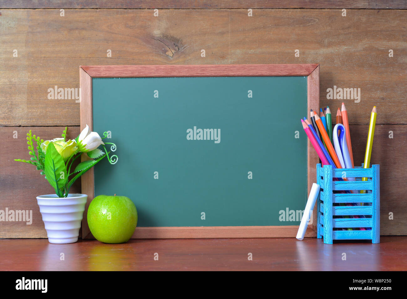 Back to School concept with apple on table in front of chalkboard Stock ...