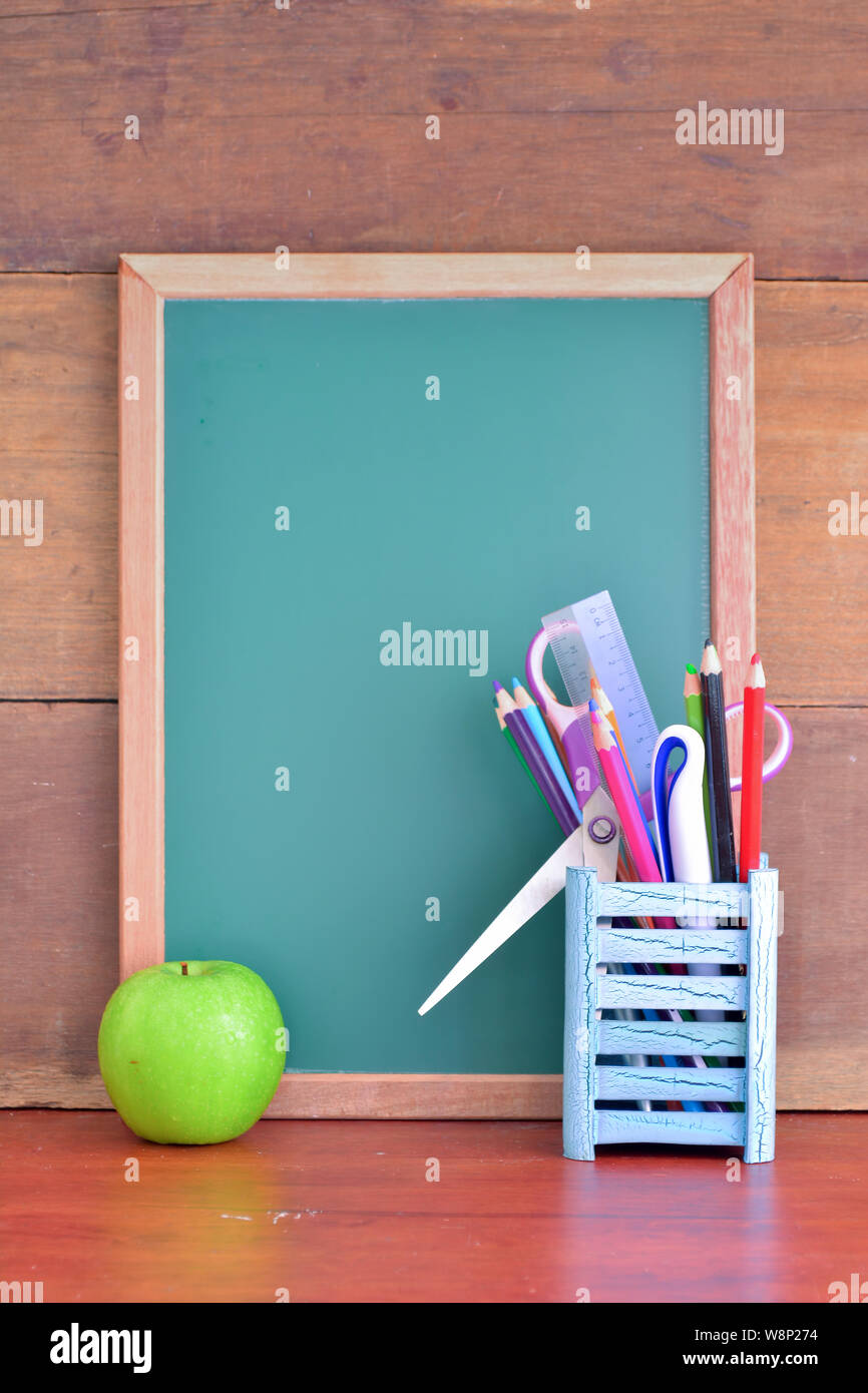 Back to School concept with apple on table in front of chalkboard Stock ...