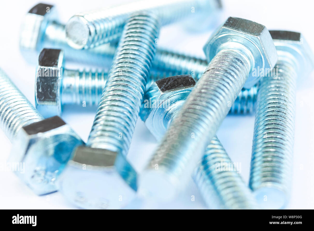 Metal bolts in a row background. Chromed screw bolts isolated. Steel ...