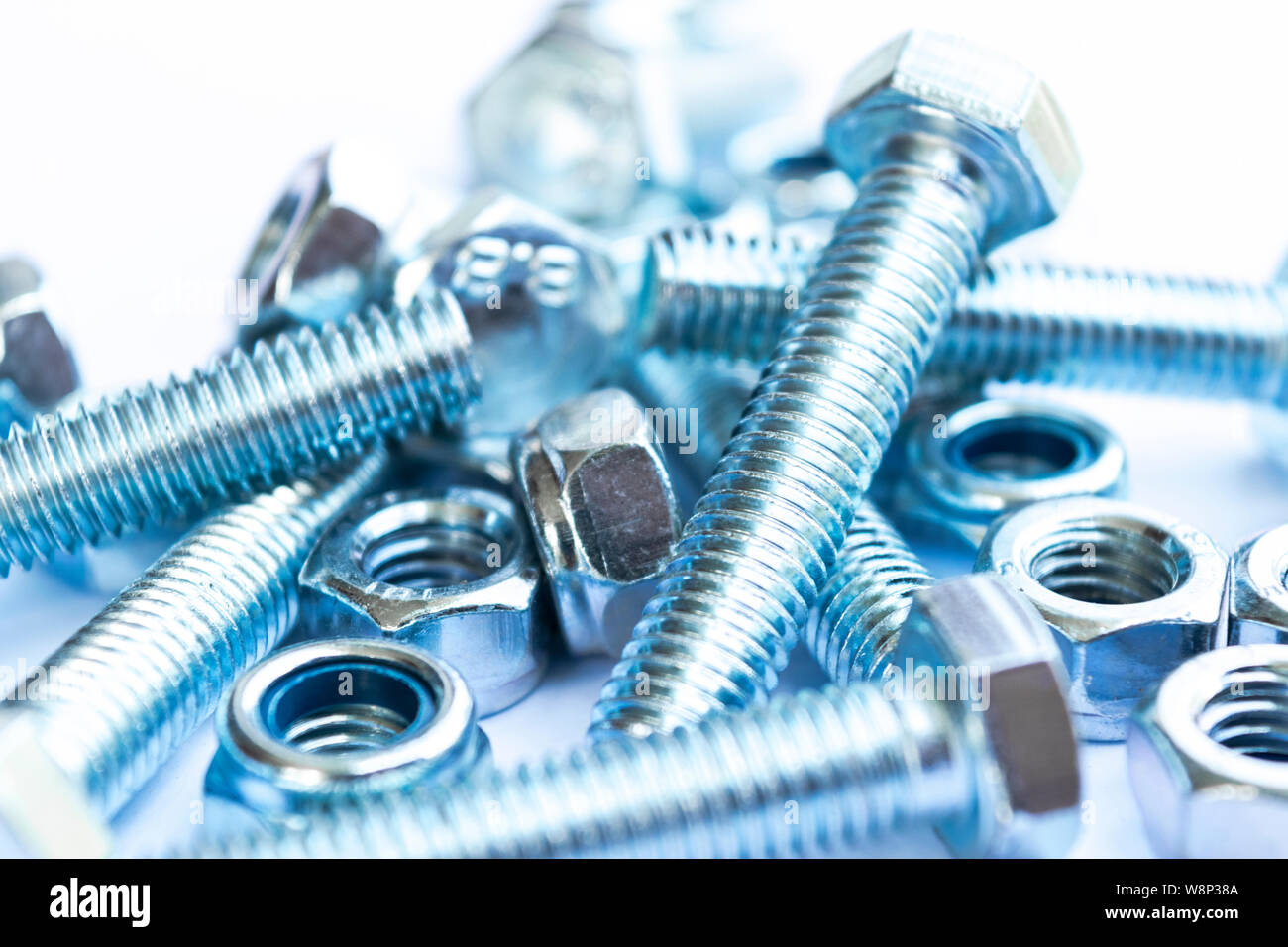 Metal bolts and nuts in a row background. Chromed screw bolts and nuts ...