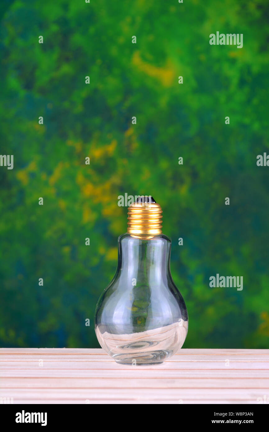 Bulb on green background Stock Photo - Alamy