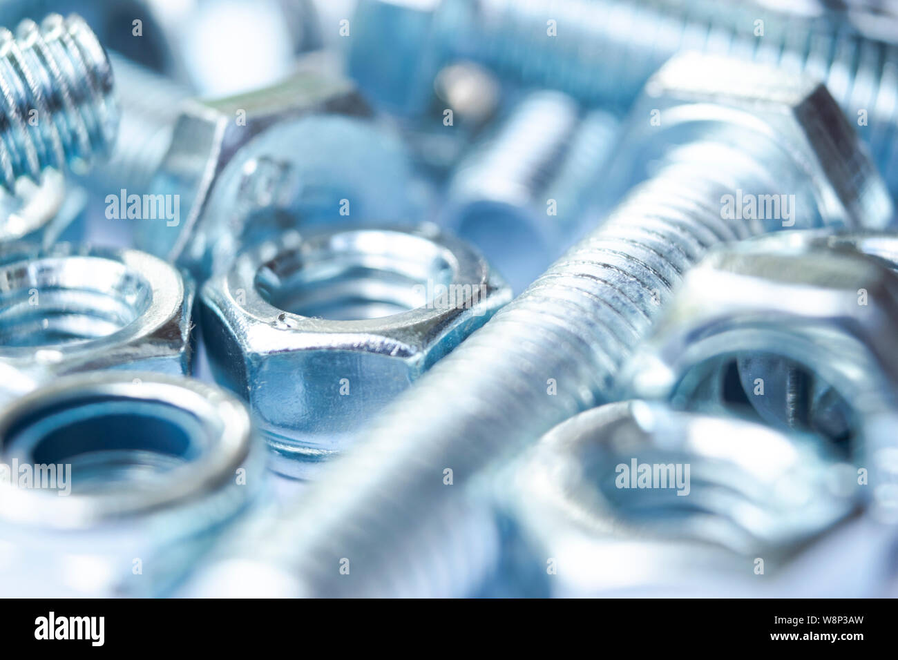 Metal bolts and nuts in a row background. Chromed screw bolts and nuts ...