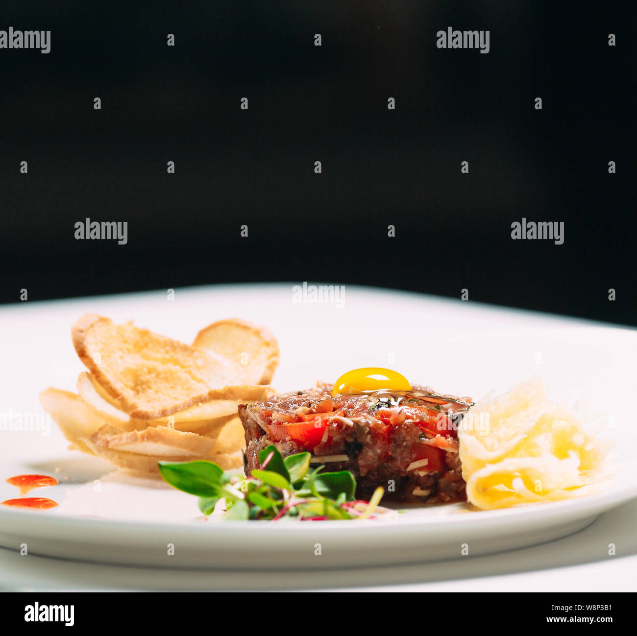 Tartar dish in the restaurant on the white plate Stock Photo - Alamy