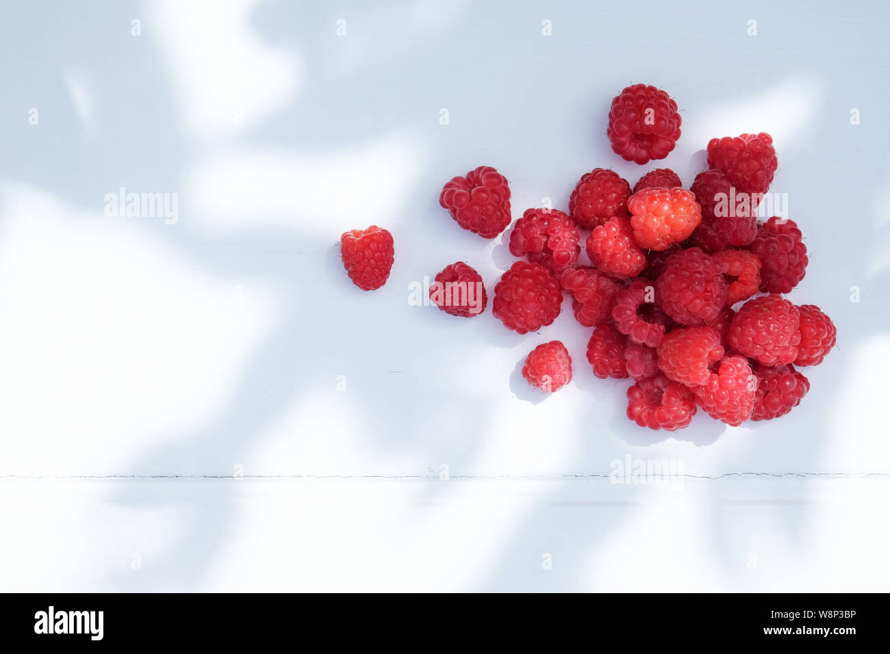 ripe fresh red raspberries isolated on a white background with shadows ...