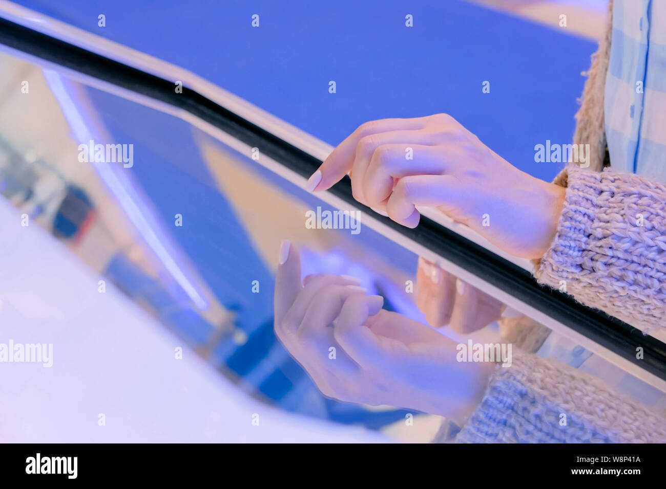 Woman using multimedia touchscreen display of interactive kiosk Stock ...