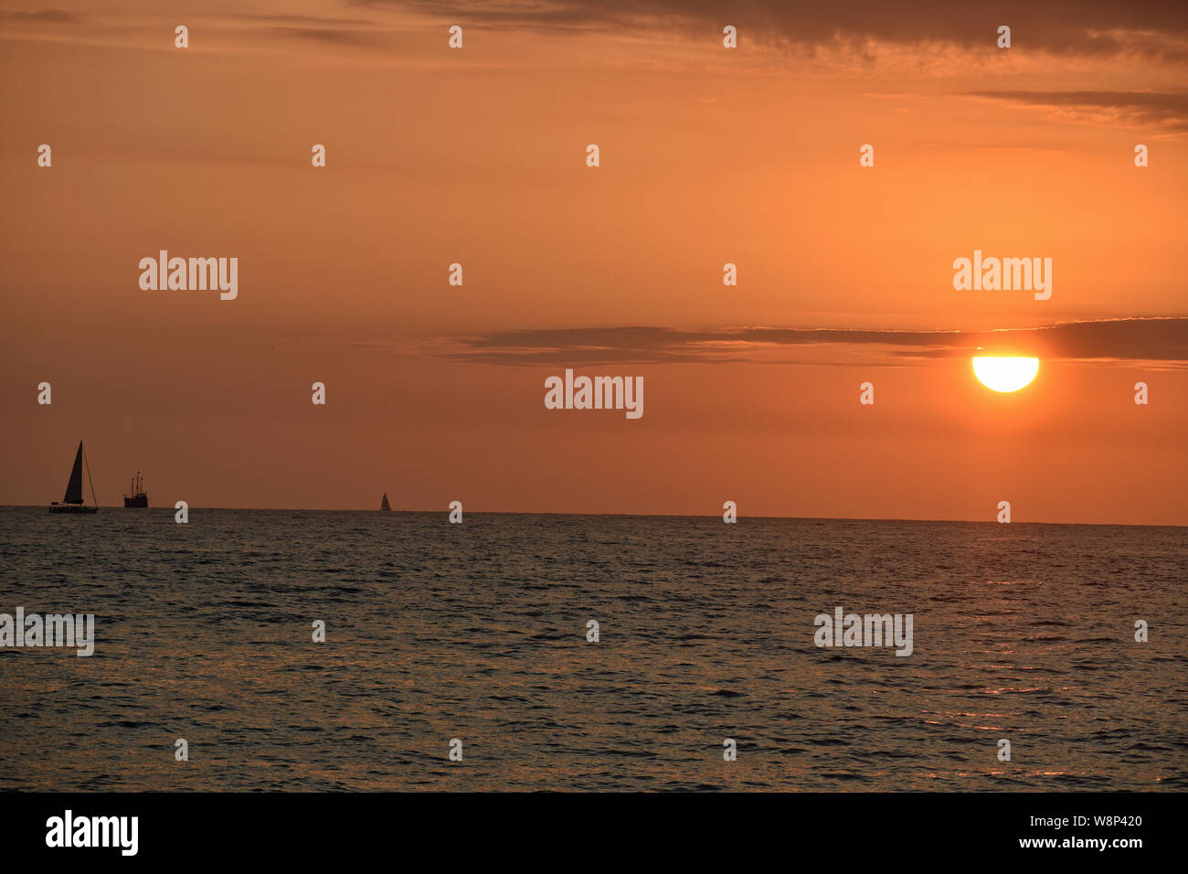 Sailboats at Sunset Stock Photo - Alamy