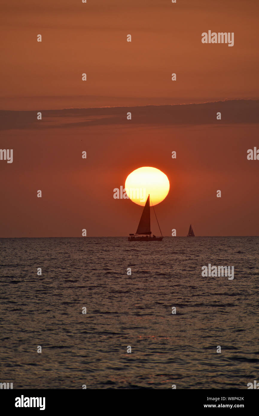 Sailboats at Sunset Stock Photo - Alamy